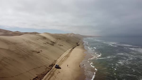 Sandwich Harbour massive sand dunes on the shore of the ocean - HD ...