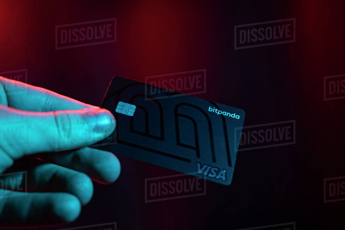 MILAN, ITALY 21 OCTOBER 2021: Credit Card in Hand detail in dark scene ...