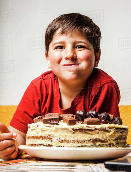 Little boy eating a cake with a chocolate - Royalty-free Stock Photo ...