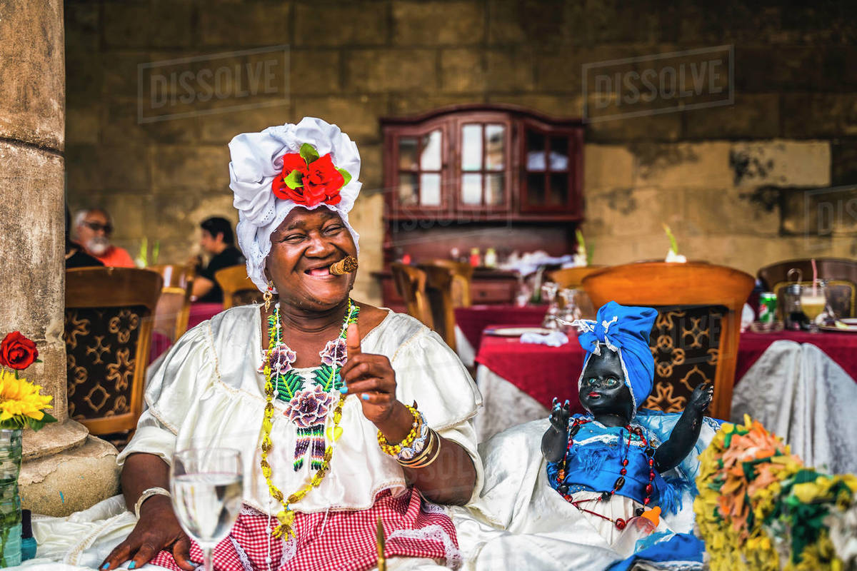 Cuban woman posing for photos while smoking big Cuban cigar in La ...