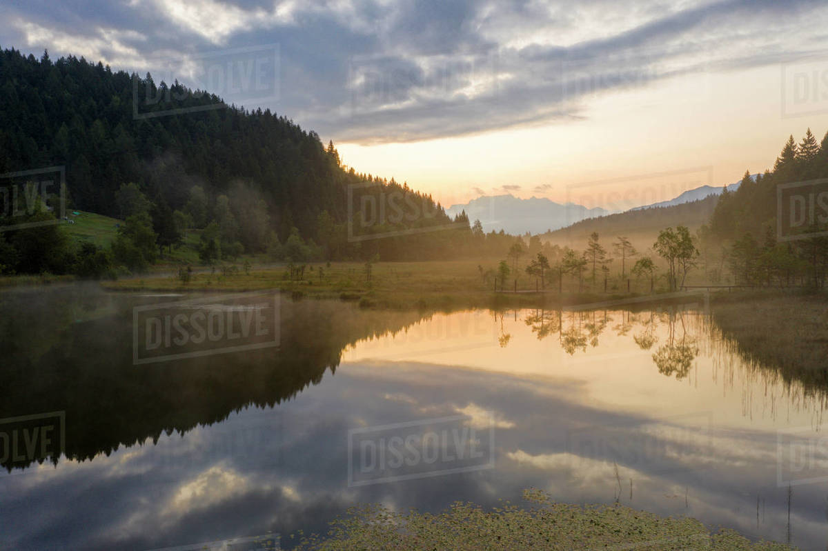 Aerial view of the misty sunrise over swamp of Pian di Gembro Nature ...