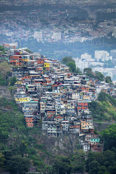 Elevated view of a favela slum on the edge of Tijuca forest, Rio de ...
