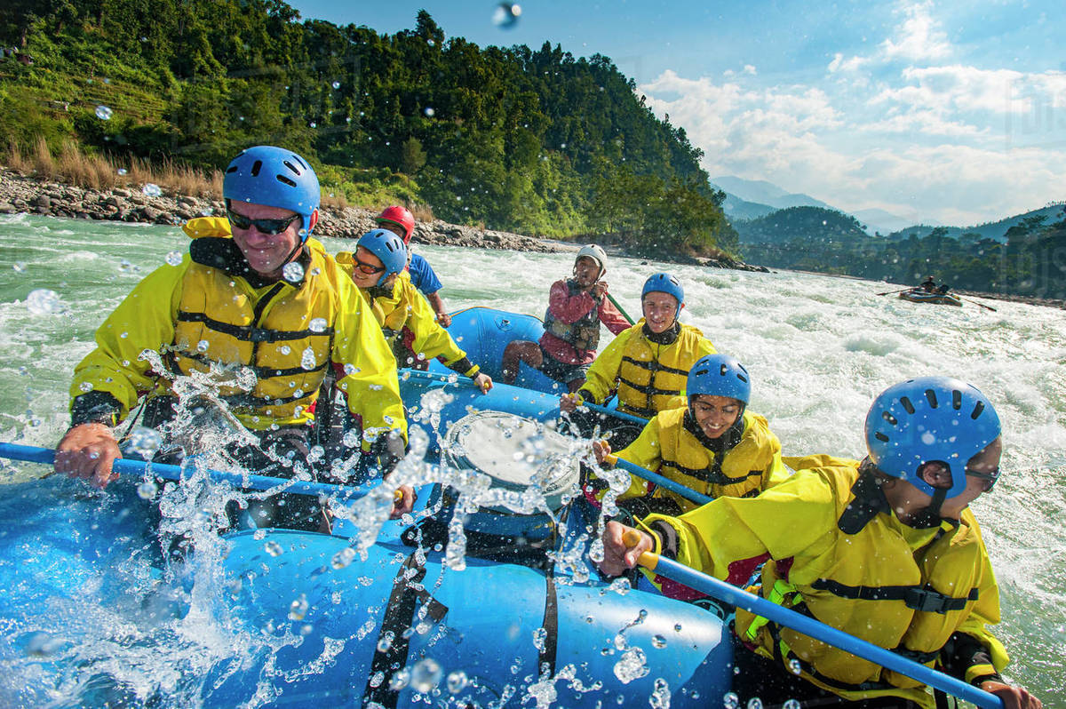 Rafters get splashed as they go through some big rapids on the Trisuli ...