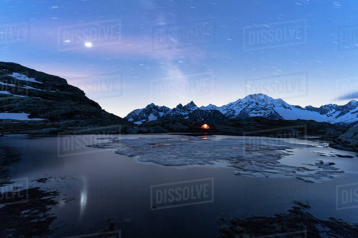 Tent under starry sky and Milky Way with Monte Disgrazia in background ...