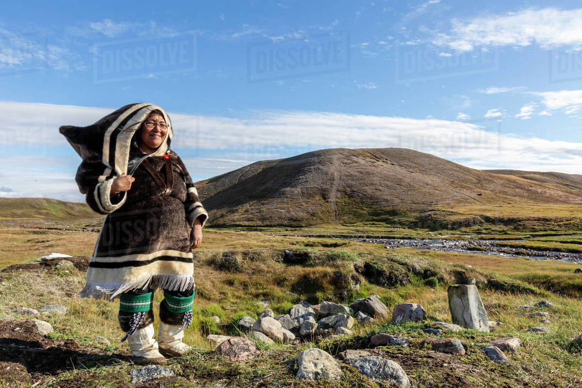 Inuit woman in traditional handmade clothing, Pond Inlet, Mittimatalik ...