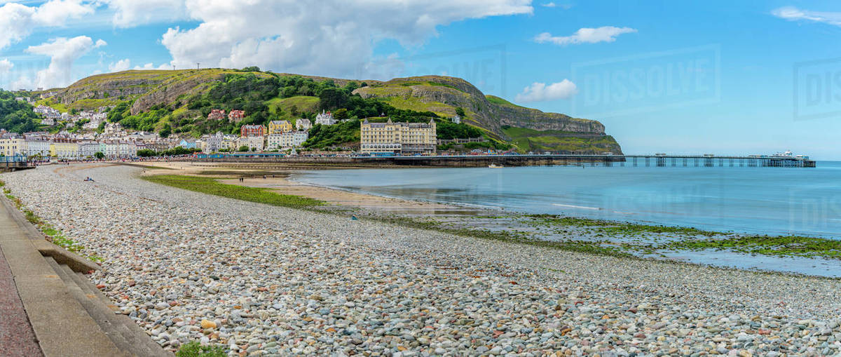 View of Llandudno Pier and the Great Orme in background from promenade ...