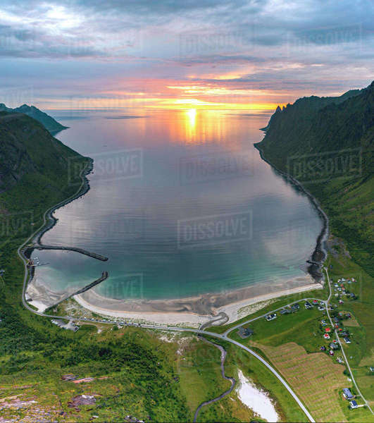 Midnight sun over Ersfjord beach overlooking the Arctic sea, aerial ...