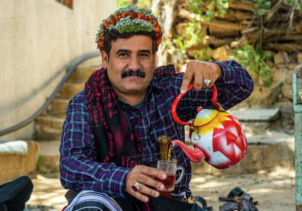 Traditional dressed man of the Qahtani Flower men tribe, serving tea ...