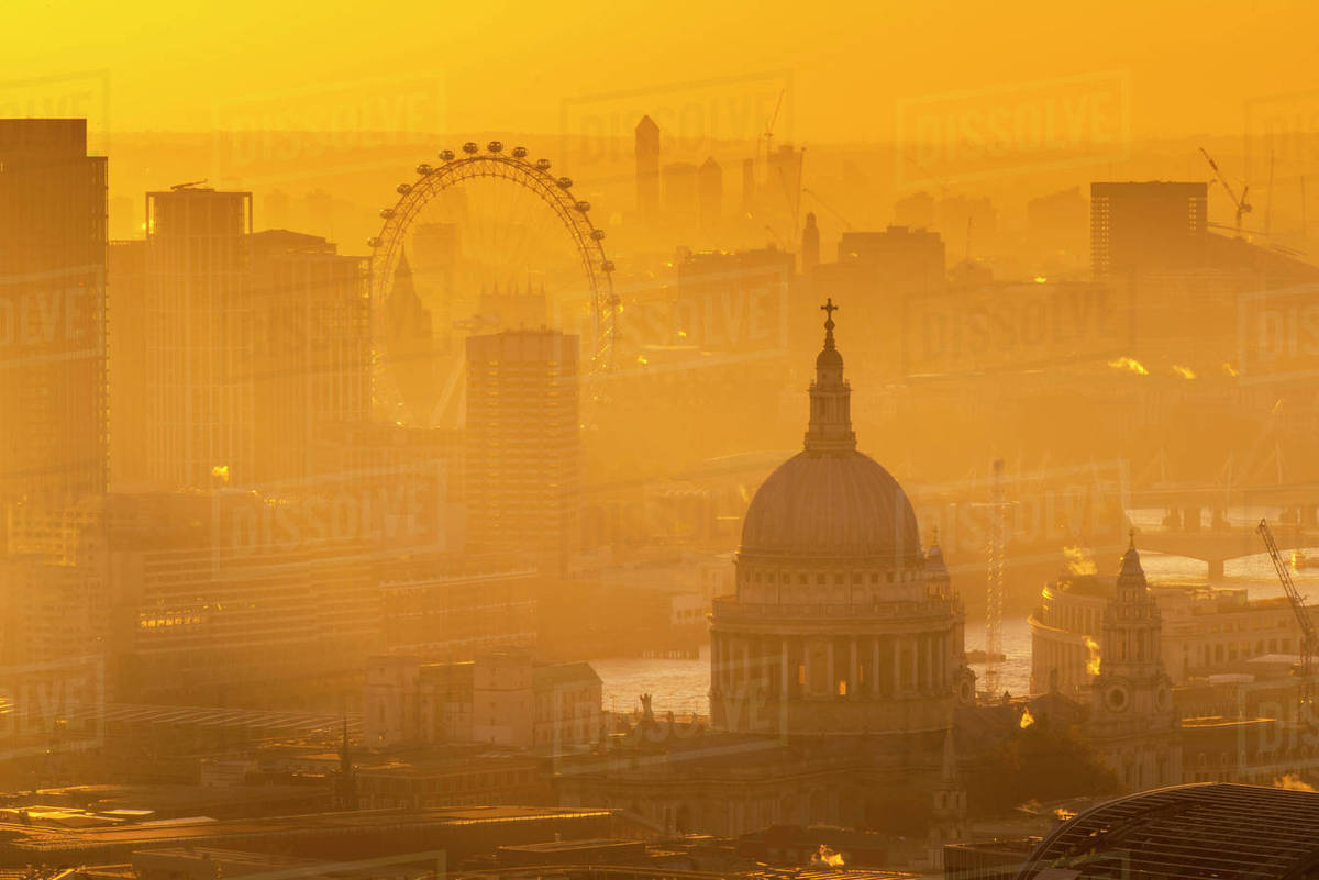 View of London Eye and St. Paul's Cathedral at golden hour from the ...