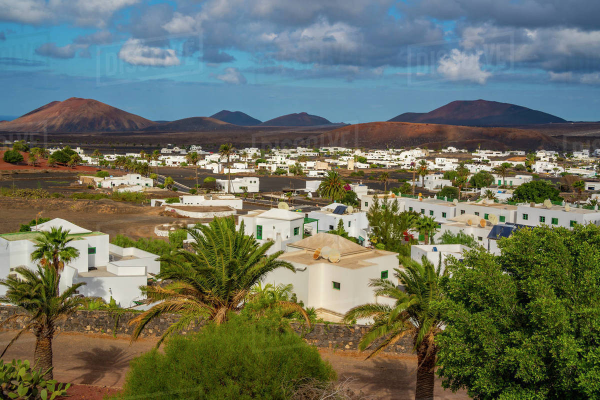 View of town from elevated position with mountainous backdrop, Yaisa ...