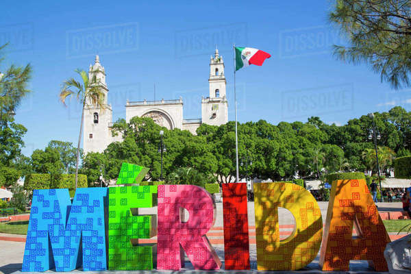 Merida Sign, Mexican flag, Plaza Grande, Cathedral de IIdefonso in the ...