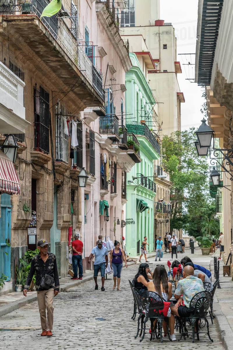 Typical street scene, cafe tables spilling out onto the street, Old Havana, Cuba, West Indies ...