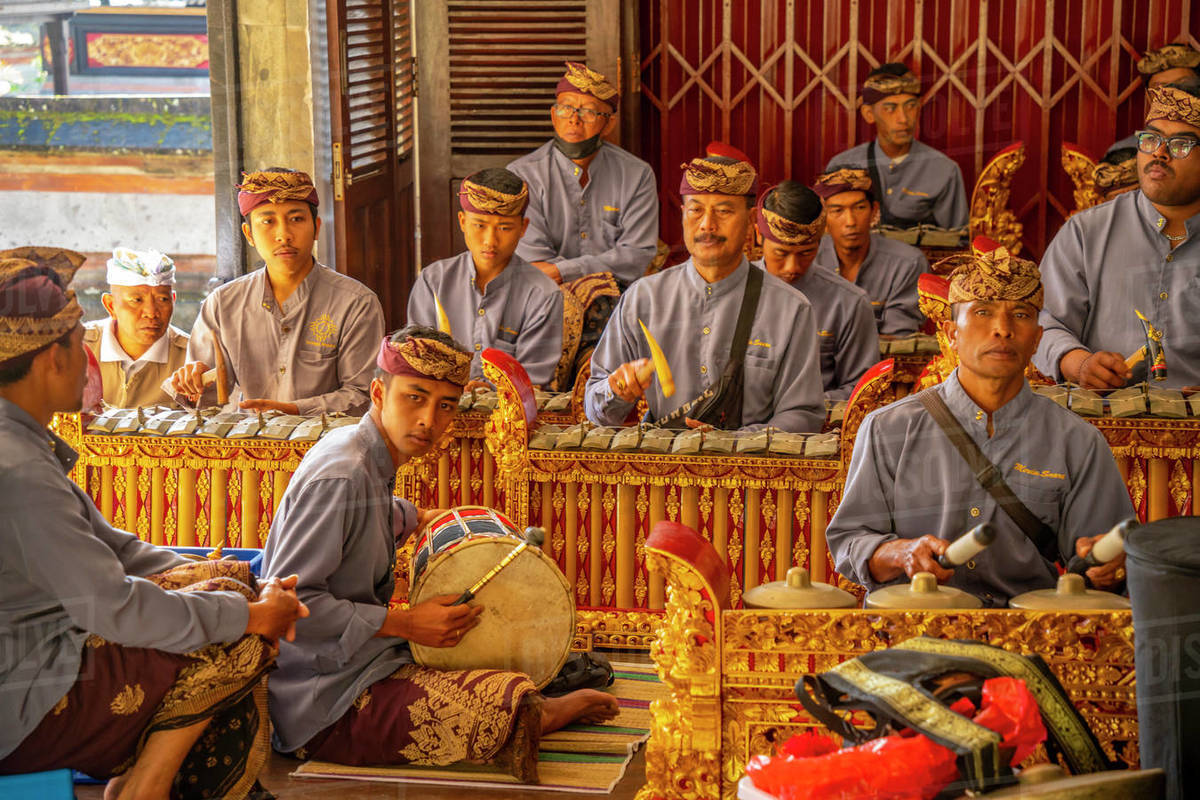 Locals playing Gamelan Saron Gangsa, traditional musical instruments ...