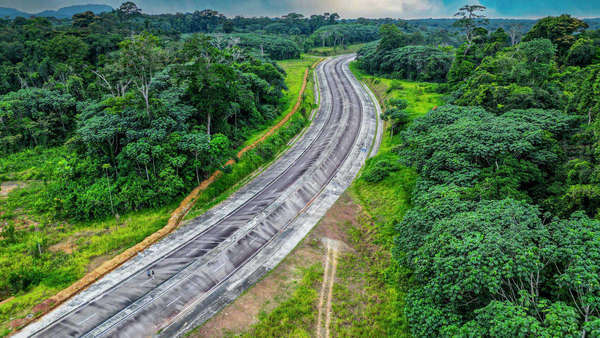 Empty highway in the jungle, future capital Ciudad de la Paz, Rio Muni ...