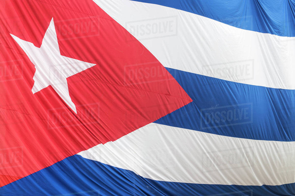 Cuban flag hanging across buildings in a street in Santa Clara, after ...