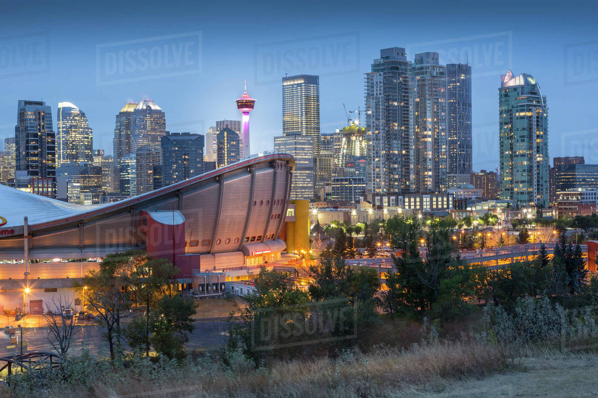 View of the Saddledome and Downtown skyline from Scottsman Hill at dusk ...