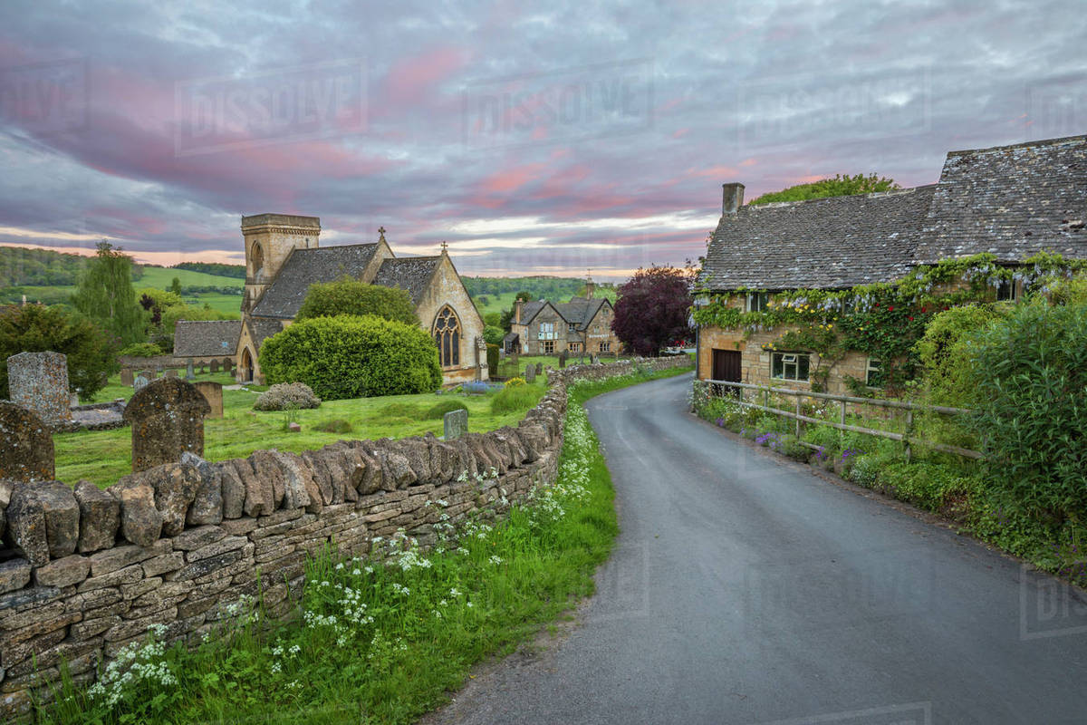 St. Barnabas church and Cotswold stone cottages at dawn, Snowshill ...