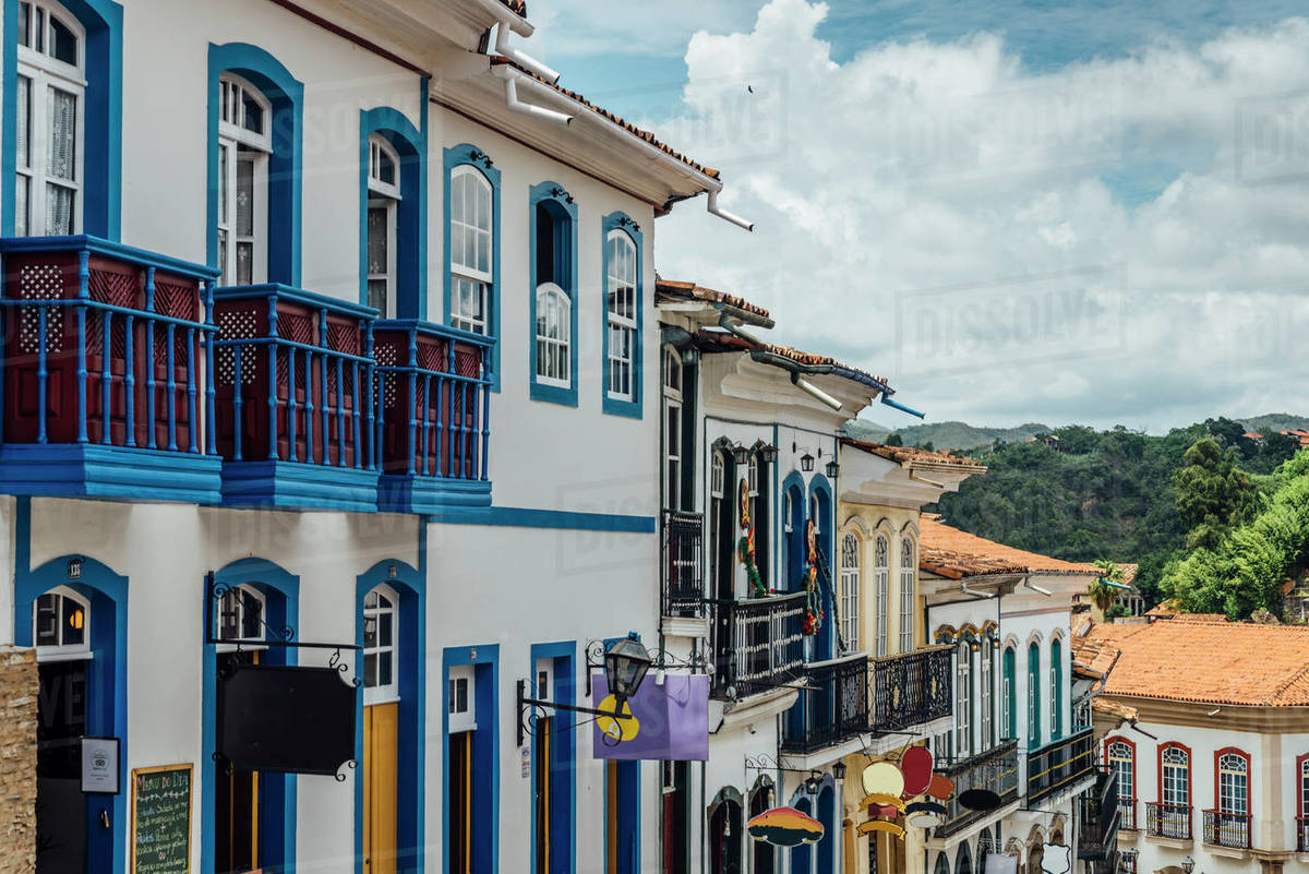 Colorful colonial buildings and narrow cobblestone streets of Ouro ...
