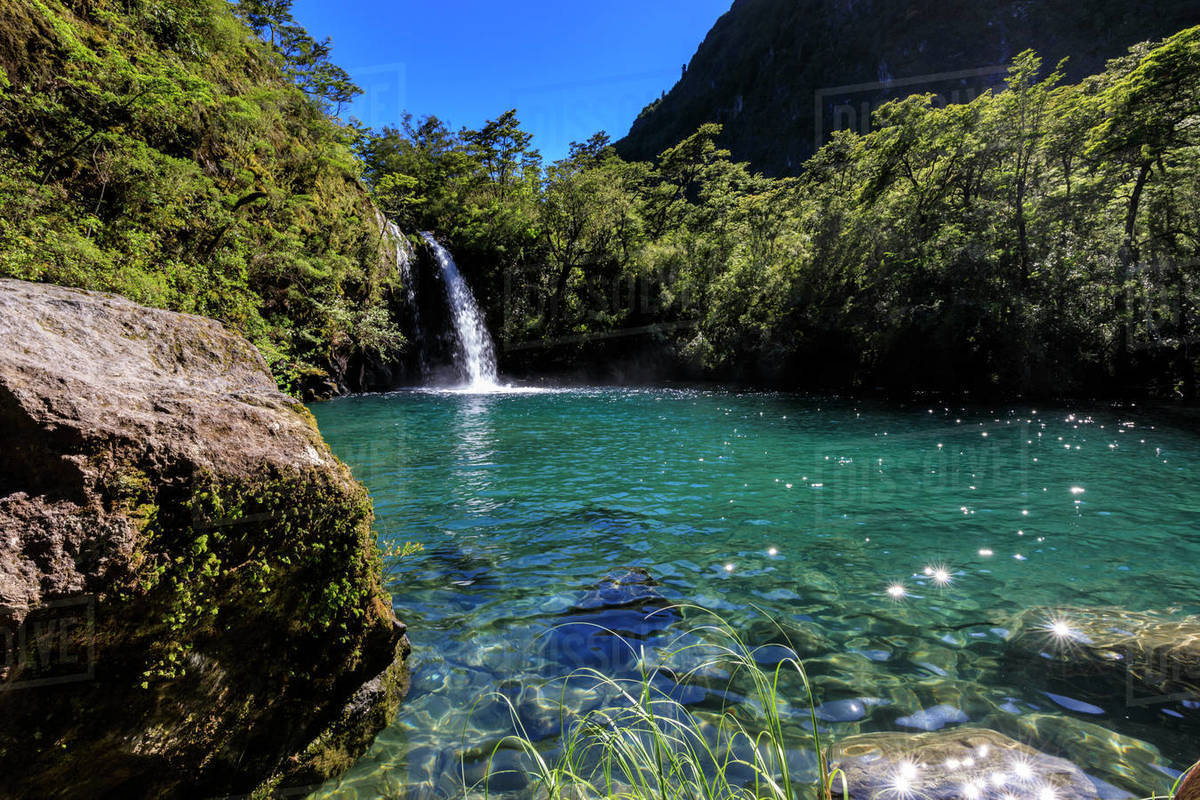 Waterfall, lake and blue sky, Petrohue Los Enamorados Trail, Vicente ...