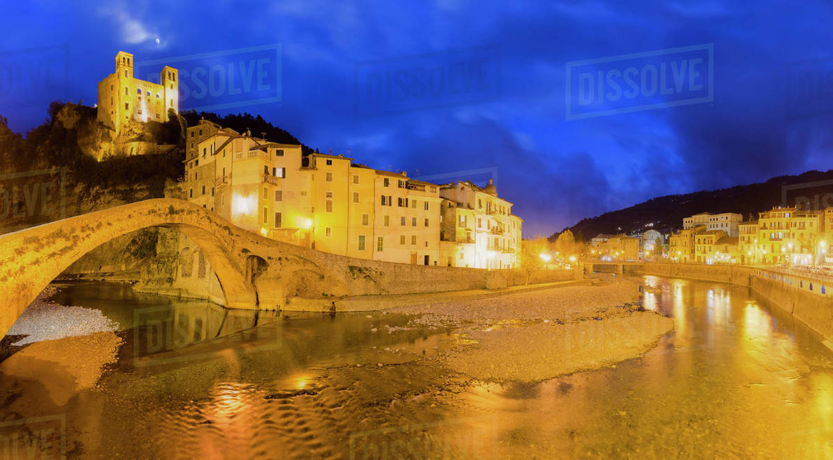 Lights reflected in the river during twilight, Dolceacqua, Province of ...