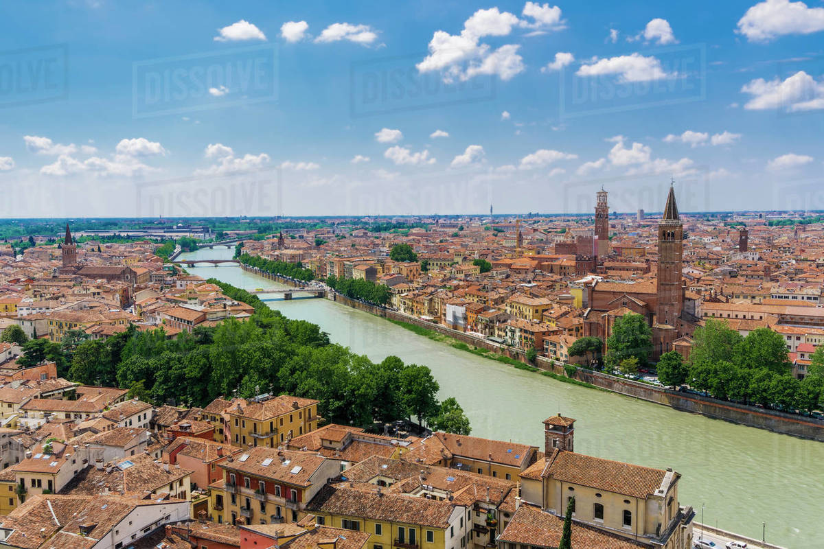 Adige River view with bridges, traditional buildings and church bell ...