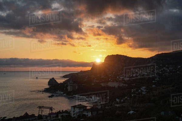 Sunet over Simeiz village with silhouette of Cat mountain and diva rock ...