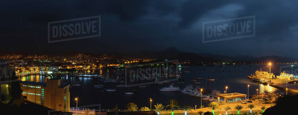 Mindelo in dusk light. Port town with many boats in the bay on the Cape ...