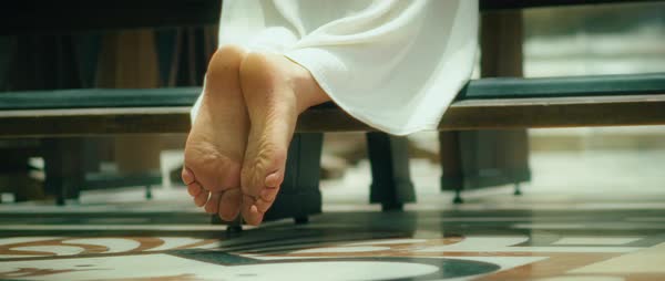 Barefoot woman in a long dress praying on her knees in church. - HD ...