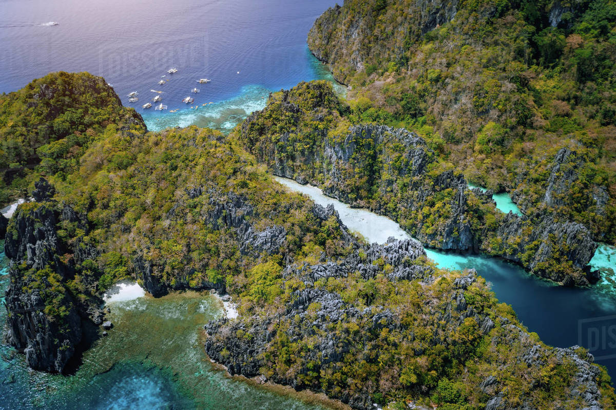 Aerial drone of entrance to big lagoon with limestone cliffs and blue ...