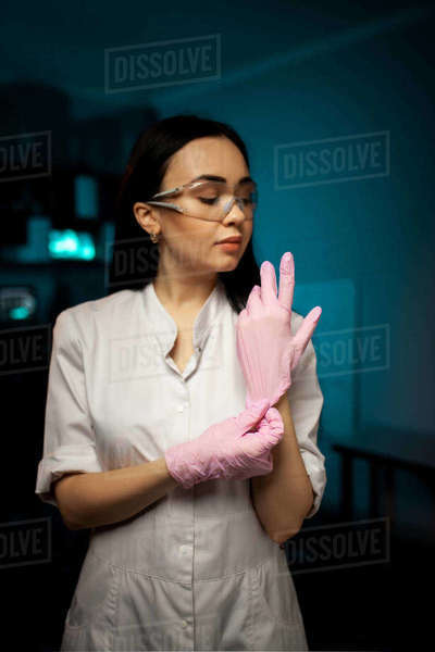 Doctor putting on sterile gloves on a lab. Vertical photo - Royalty ...