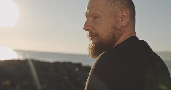 Pretty smiling man turning face to camera, rescuer, filmed on cinematic ...