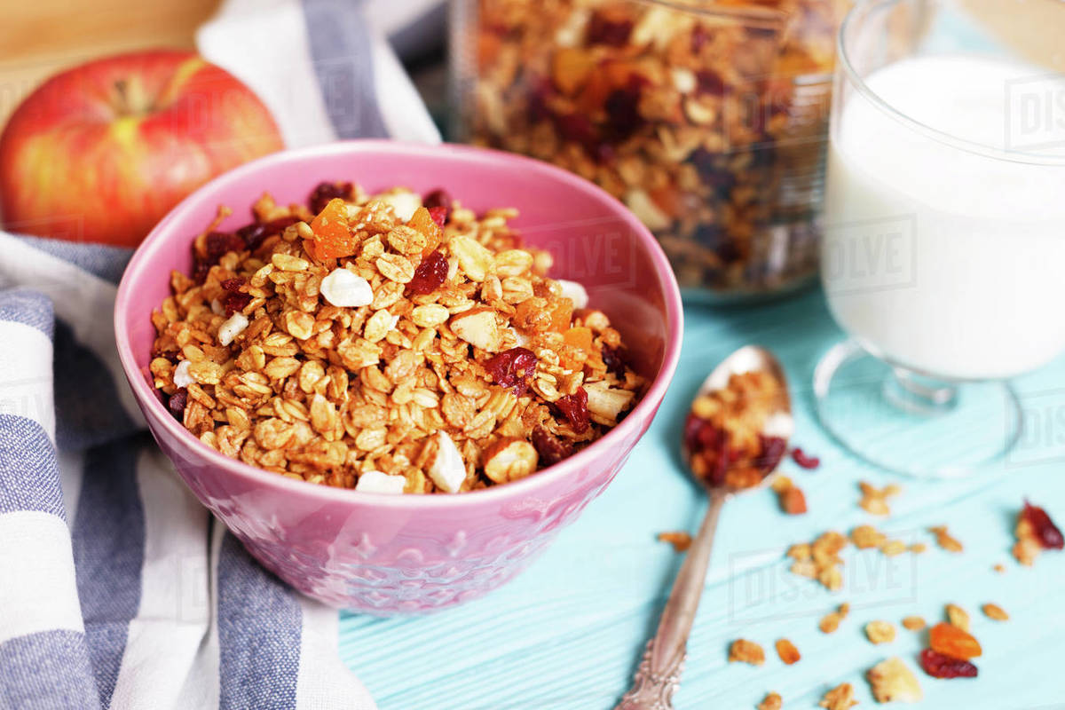 Appetizing healthy granola in bowl on blue wooden background - Stock ...