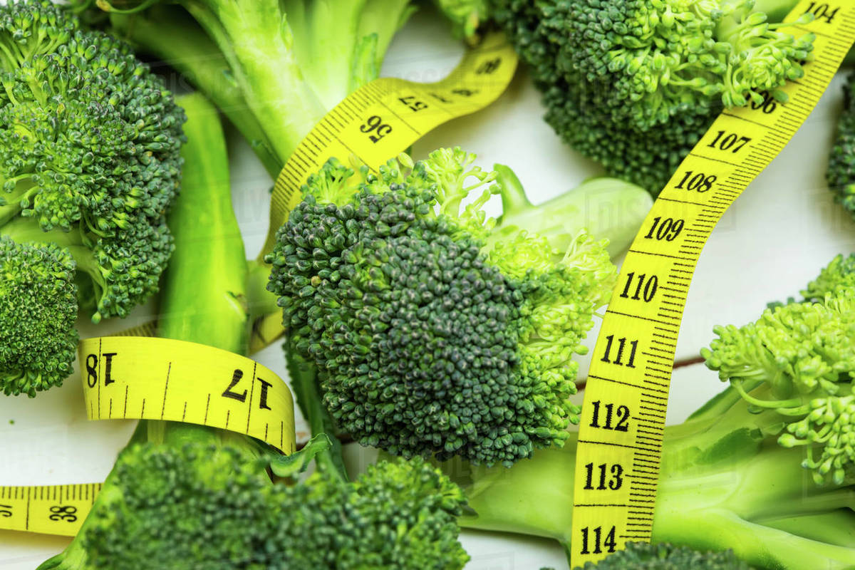 Broccoli stems with the yellow measuring tape close up shot - Stock ...