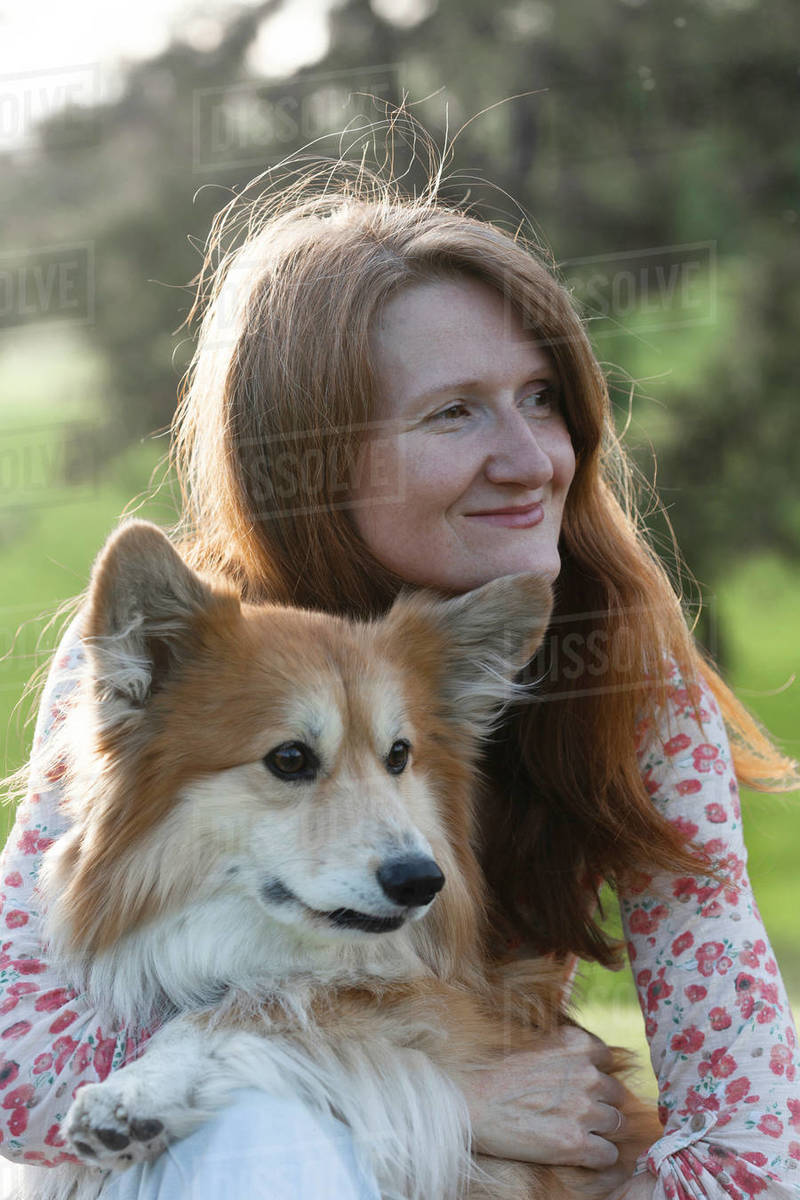 Beautiful corgi dog and girl on the lawn in the park - Royalty-free ...