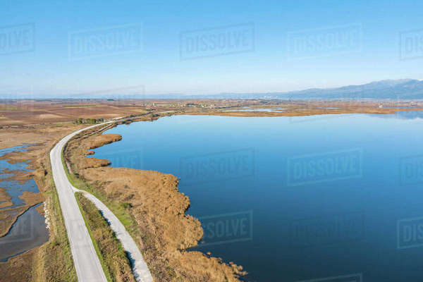 Aerial view of road passing by the lake. - Royalty-free Stock Photo ...