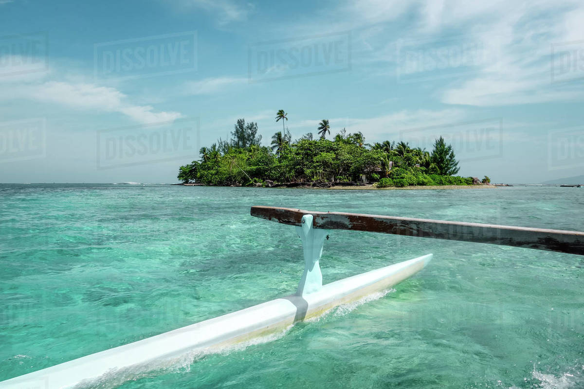 Pirogue on the way to paradise tropical atoll in Moorea Island lagoon ...