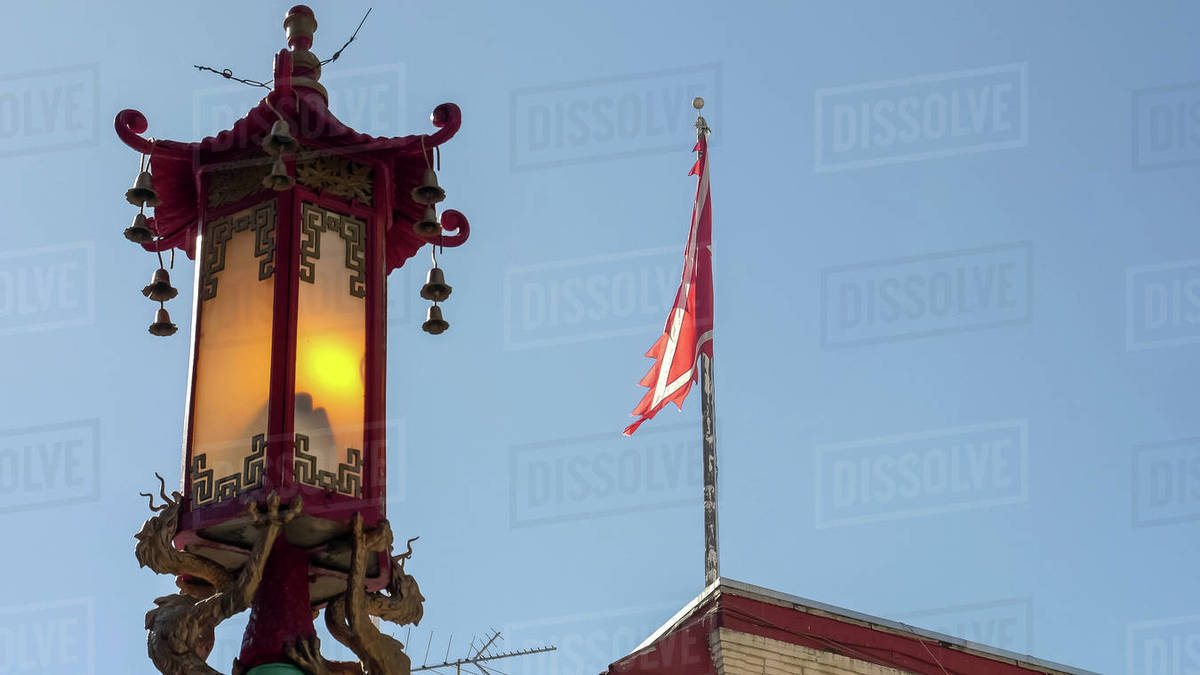 A chinese lamppost and flag in the chinatown district of san francisco ...