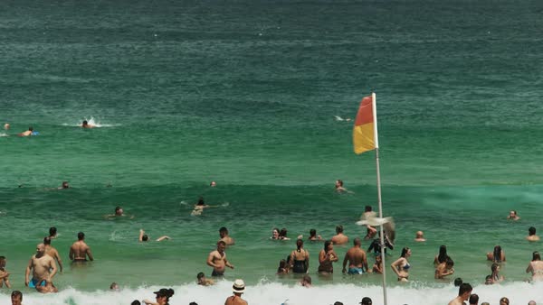 Bondi beach swimmers and surf life saving flag close up - 4K Royalty ...