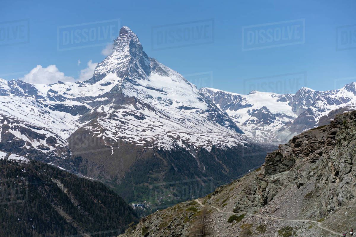a spring morning view of a hiking trail and the matterhorn mountain ...