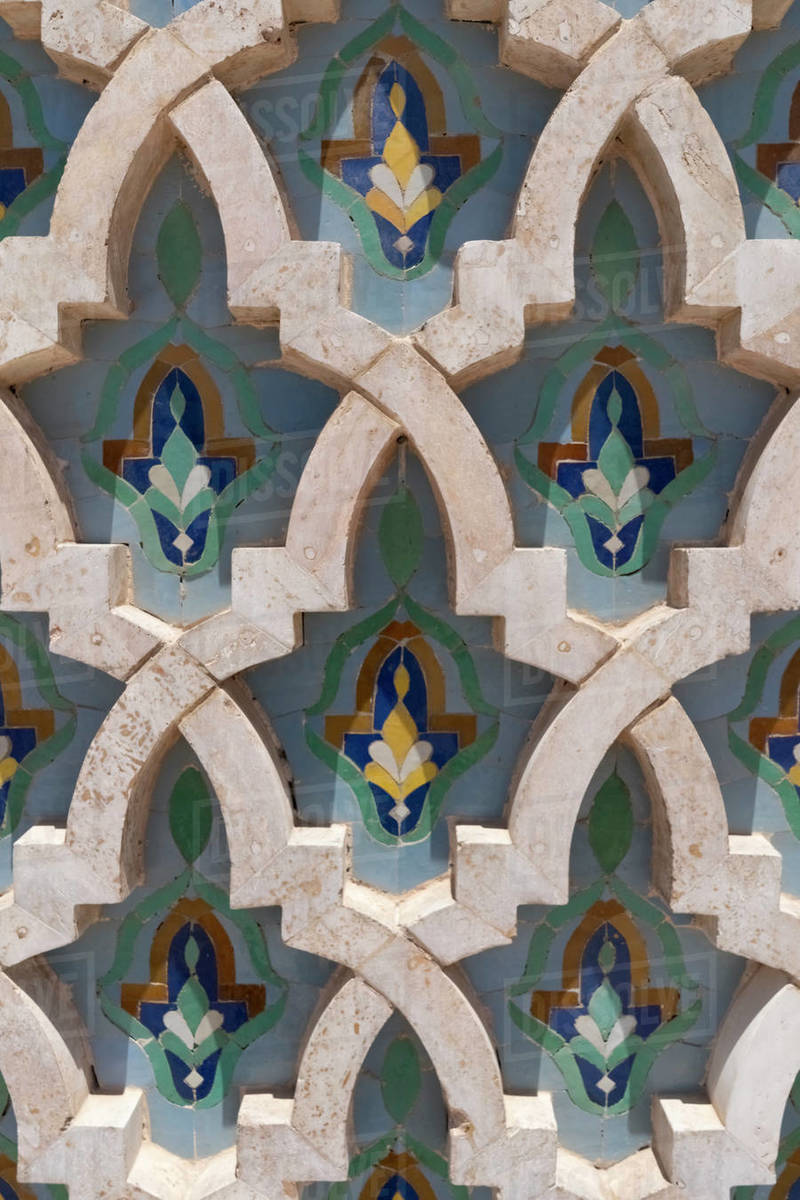 ornate masonry and tile patterns on a wall at a hassan ii mosque in ...