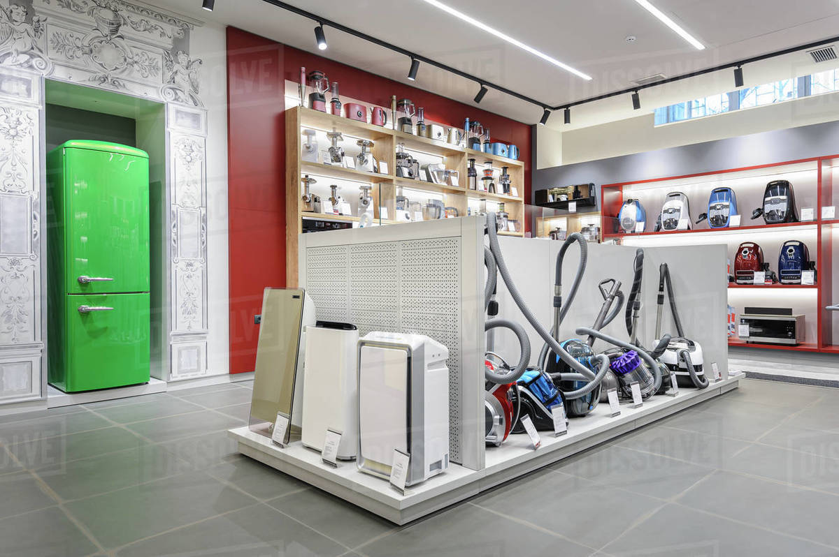 Green refrigerator and vacuum cleaners at shelves in the premium home ...