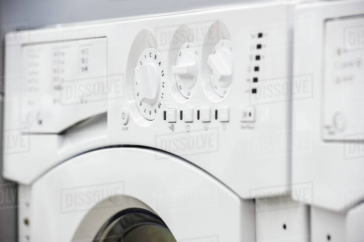 White washing machine control panel closeup in appliance store ...