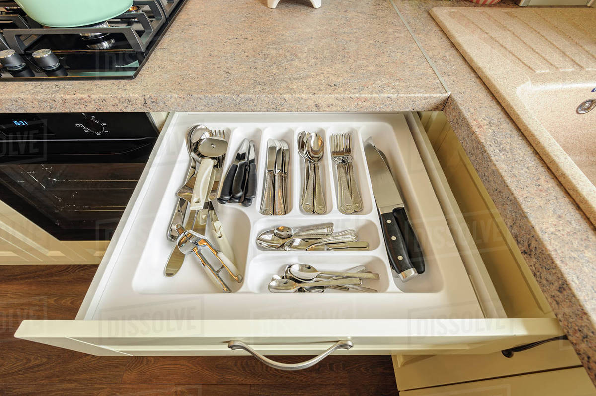 open kitchen drawer with spoons, forks and table knives inside - Stock ...