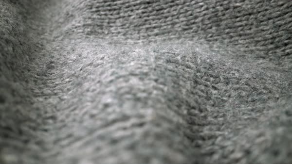 Extreme detail view of sheep wool cloth texture flowing in macro dolly ...
