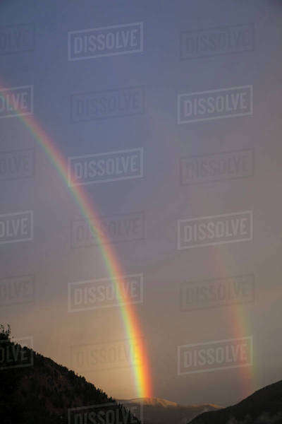 USA, Colorado, Lake City. A double rainbow forms over mountains ...