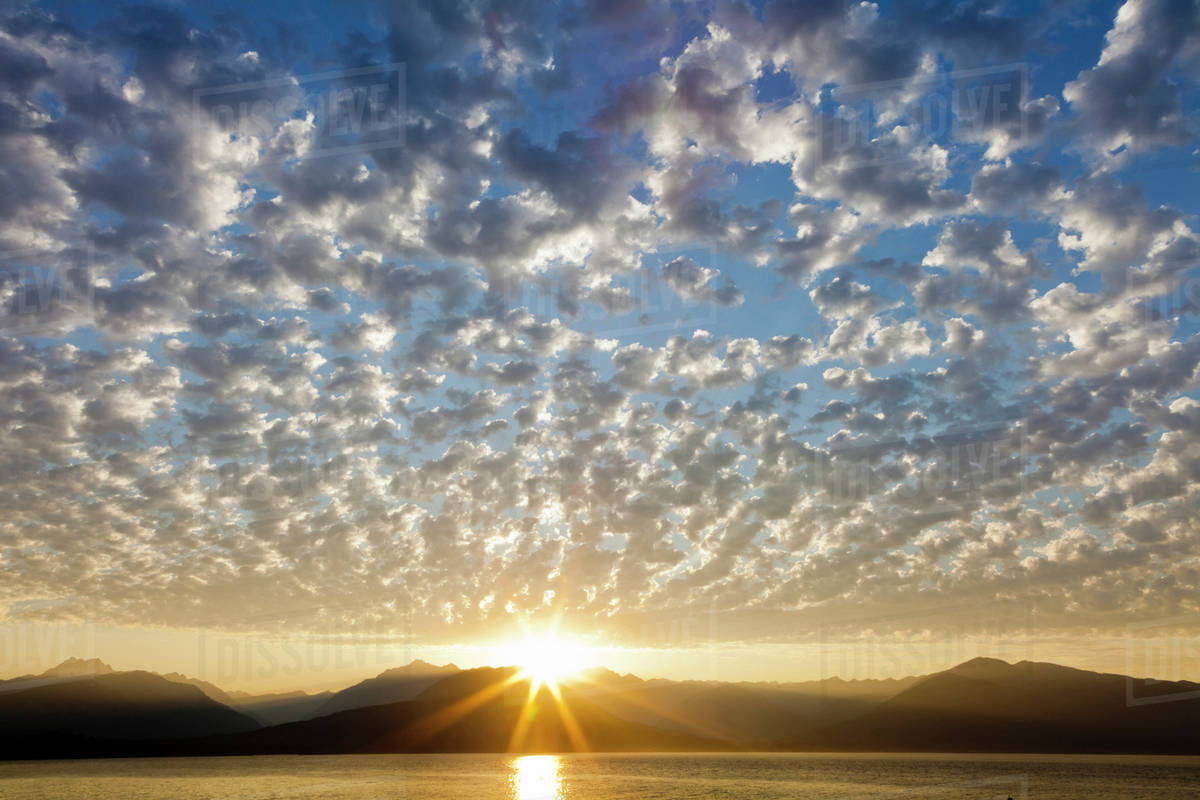 USA, Washington, Seabeck. Sunset on the Olympic Mountains and Hood ...