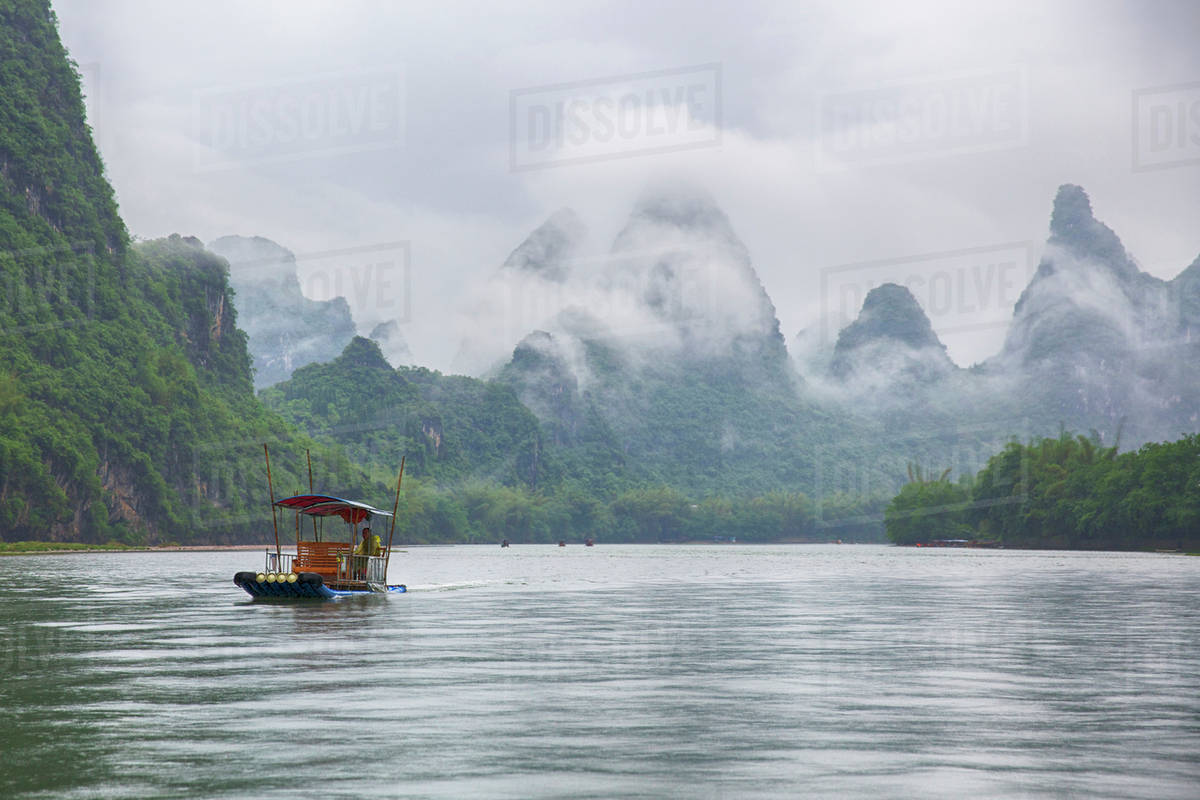 China, Yangshuo Province, Guilin. Bamboo raft on the Li River ...