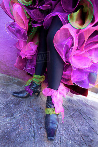 Europe, Italy, Venice. Close-up of woman's legs and shoes dressed in ...