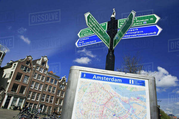 Netherlands, Amsterdam. Close-up of directional signs and city map ...