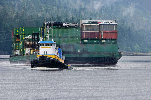 USA, Alaska, Petersburg. Tug boat pulls barge full of cargo. - Stock ...